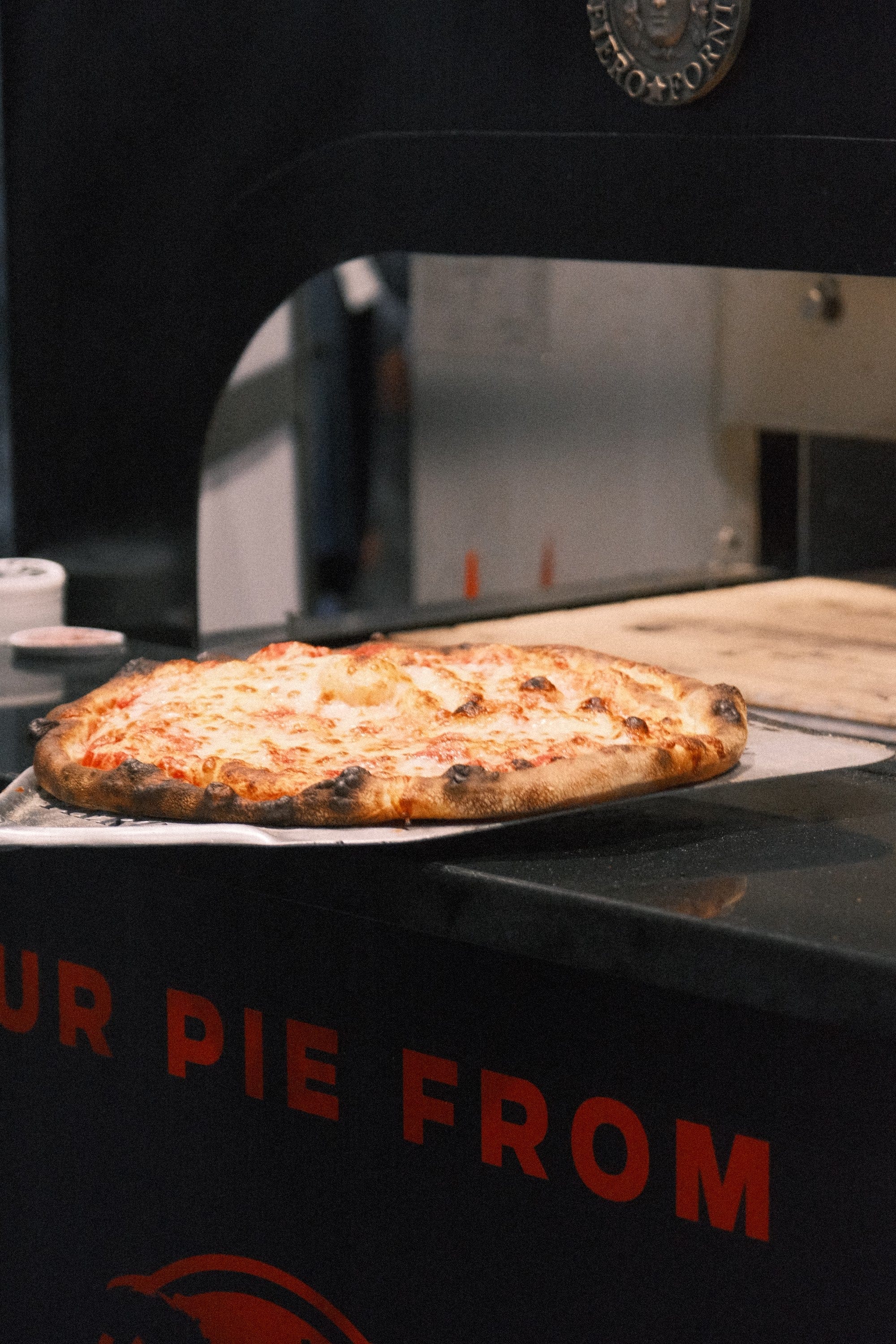 Cheese pizza made in the stone-belt conveyor oven